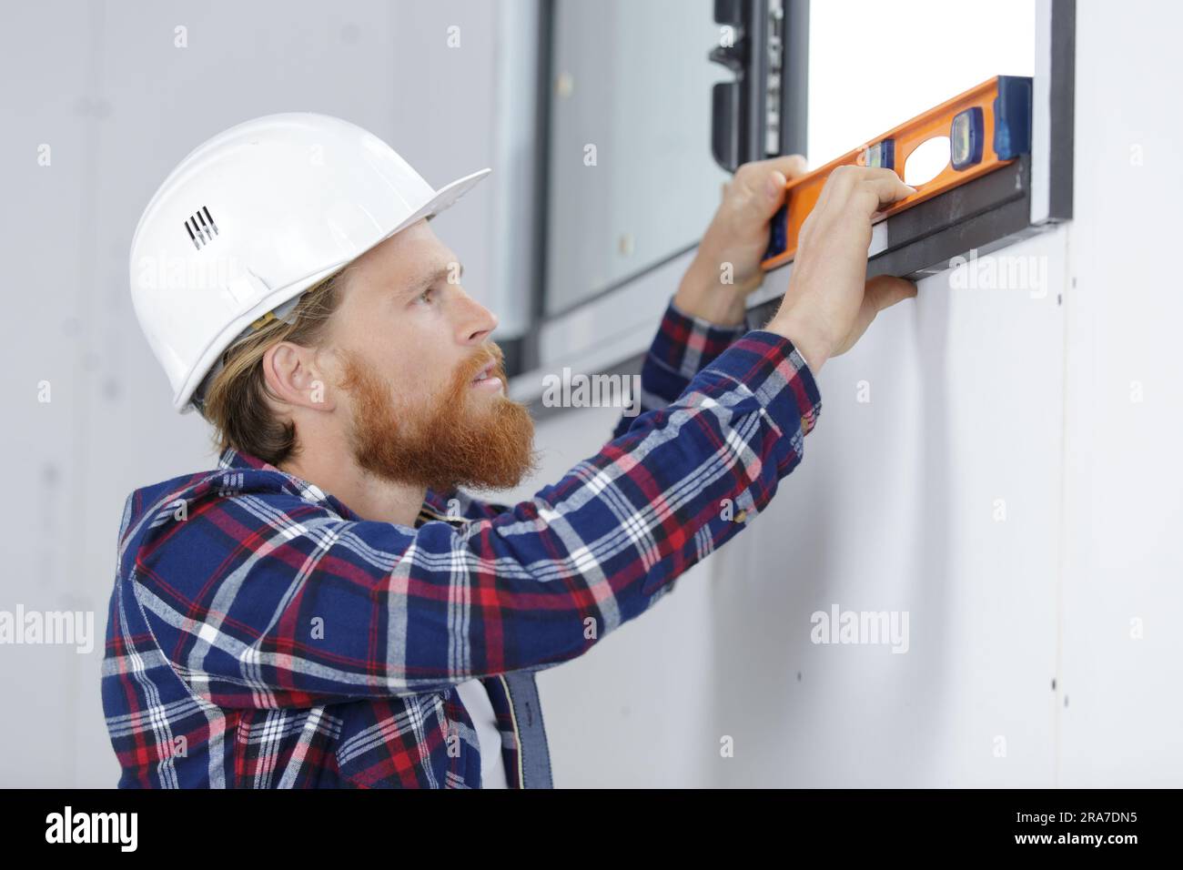 workman using special tool and checking level of window frame Stock Photo - Alamy