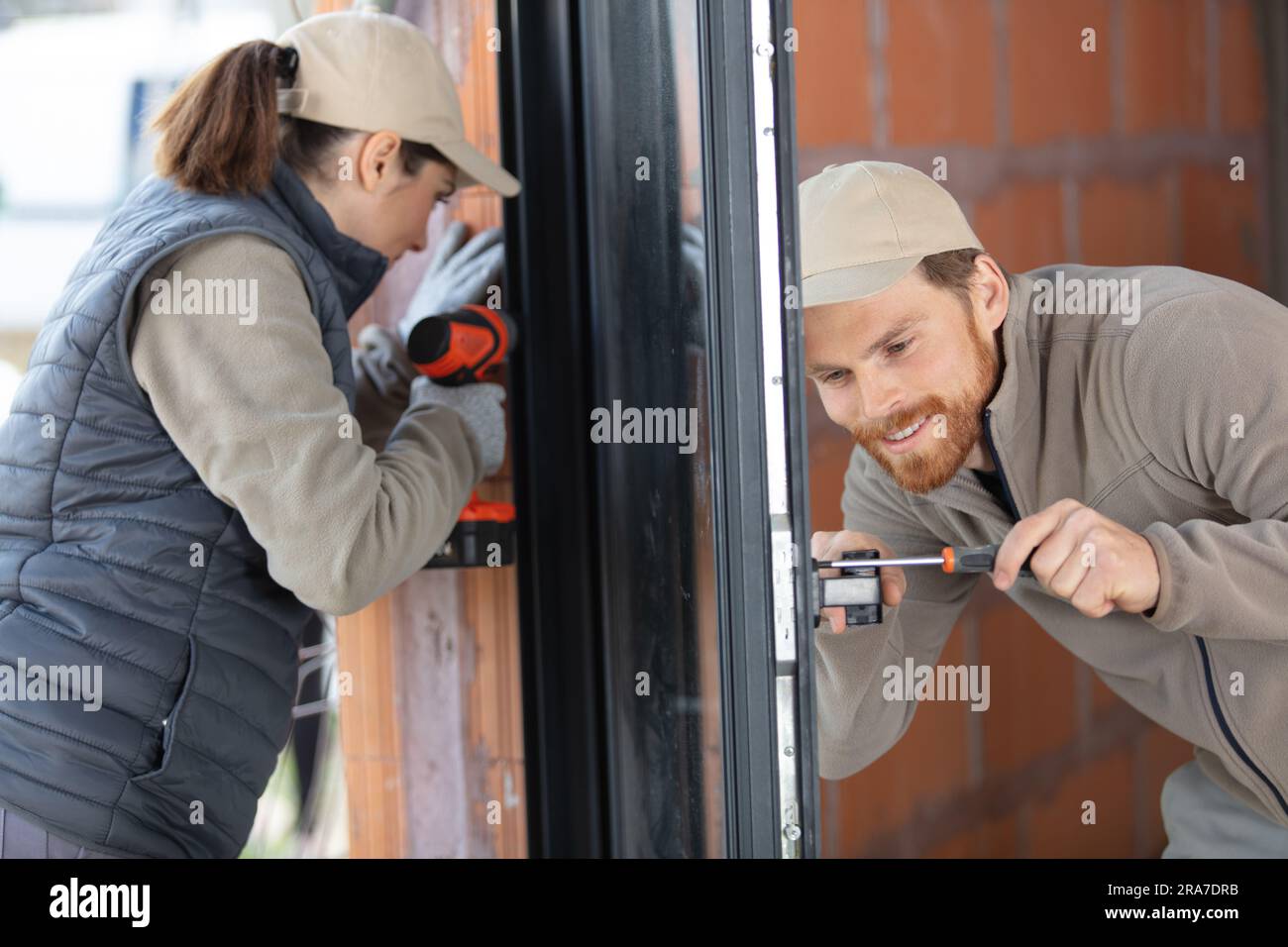 woman and man installing a window Stock Photo - Alamy