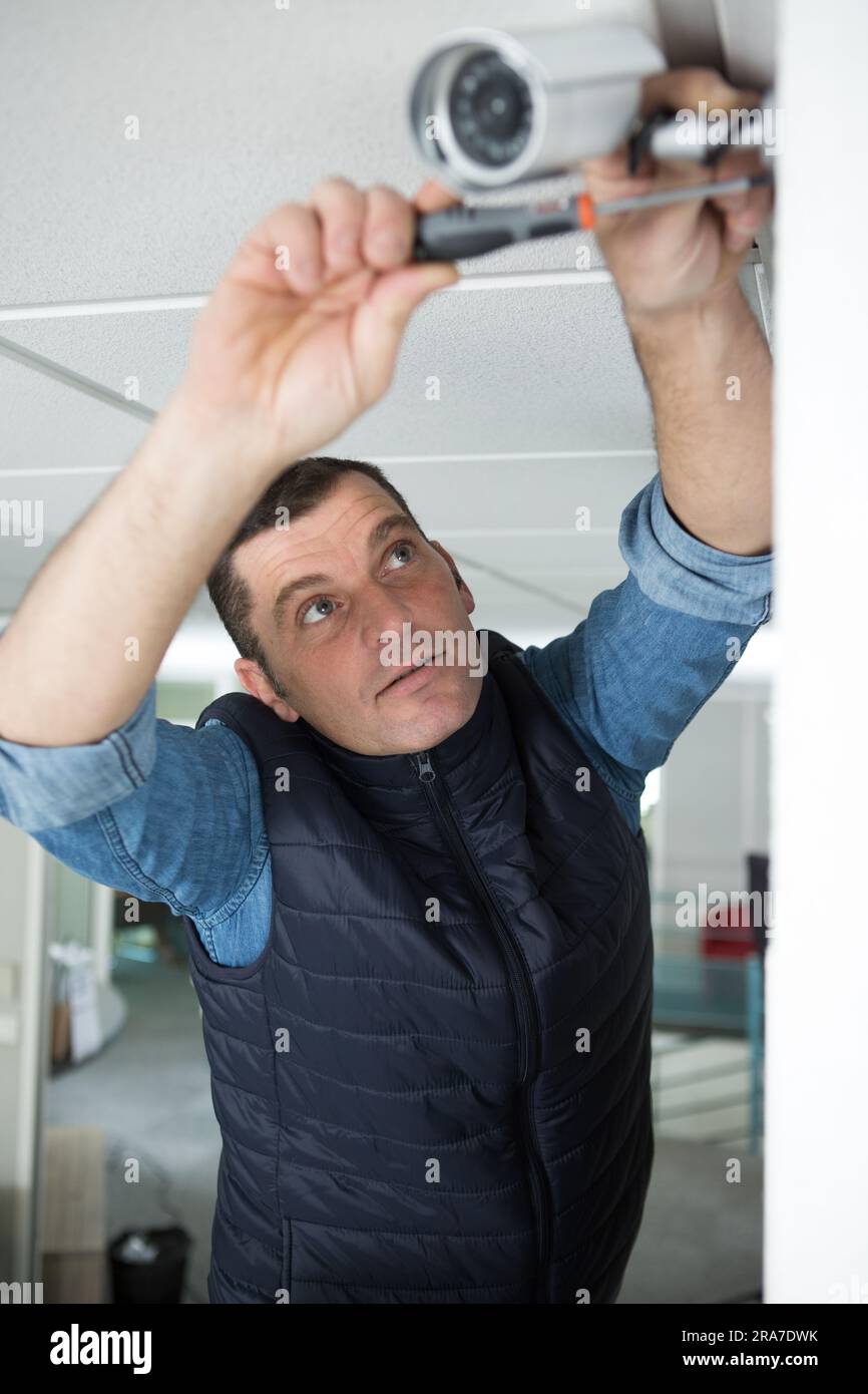 worker is ready to install the cctv camera Stock Photo - Alamy