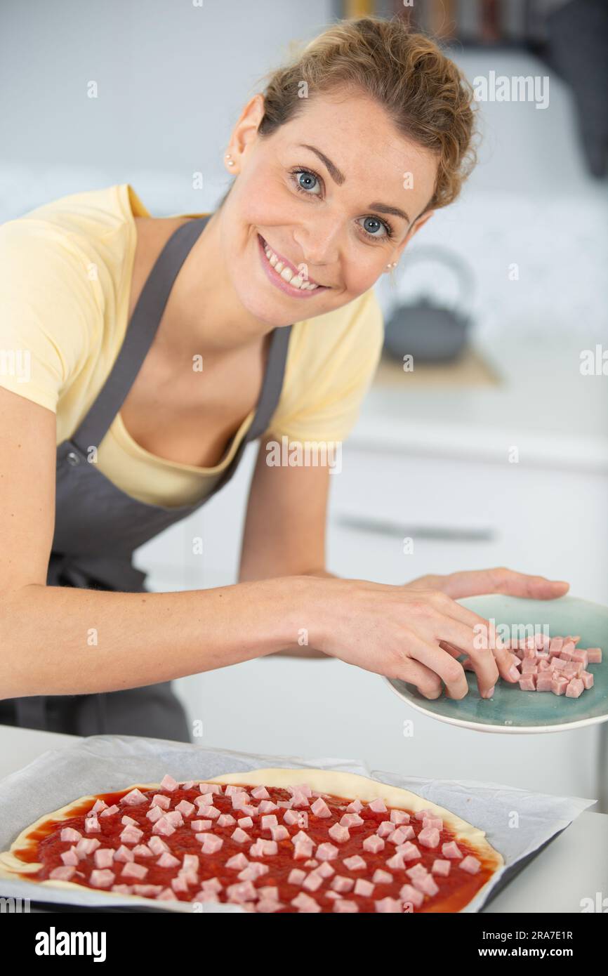 happy woman pizza cooking in a real home Stock Photo - Alamy