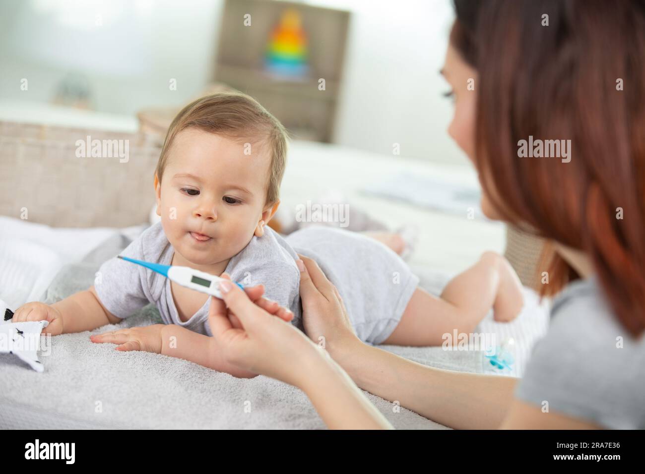 mother taking babay temperature - illness concept Stock Photo - Alamy
