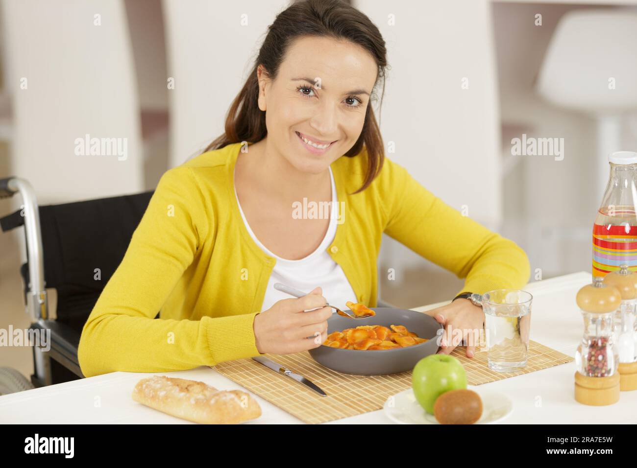 disabled young woman eating pasta Stock Photo - Alamy