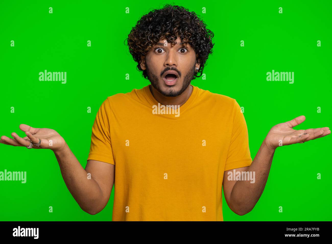 What Why. Sincere irritated indian man raising hands in indignant ...