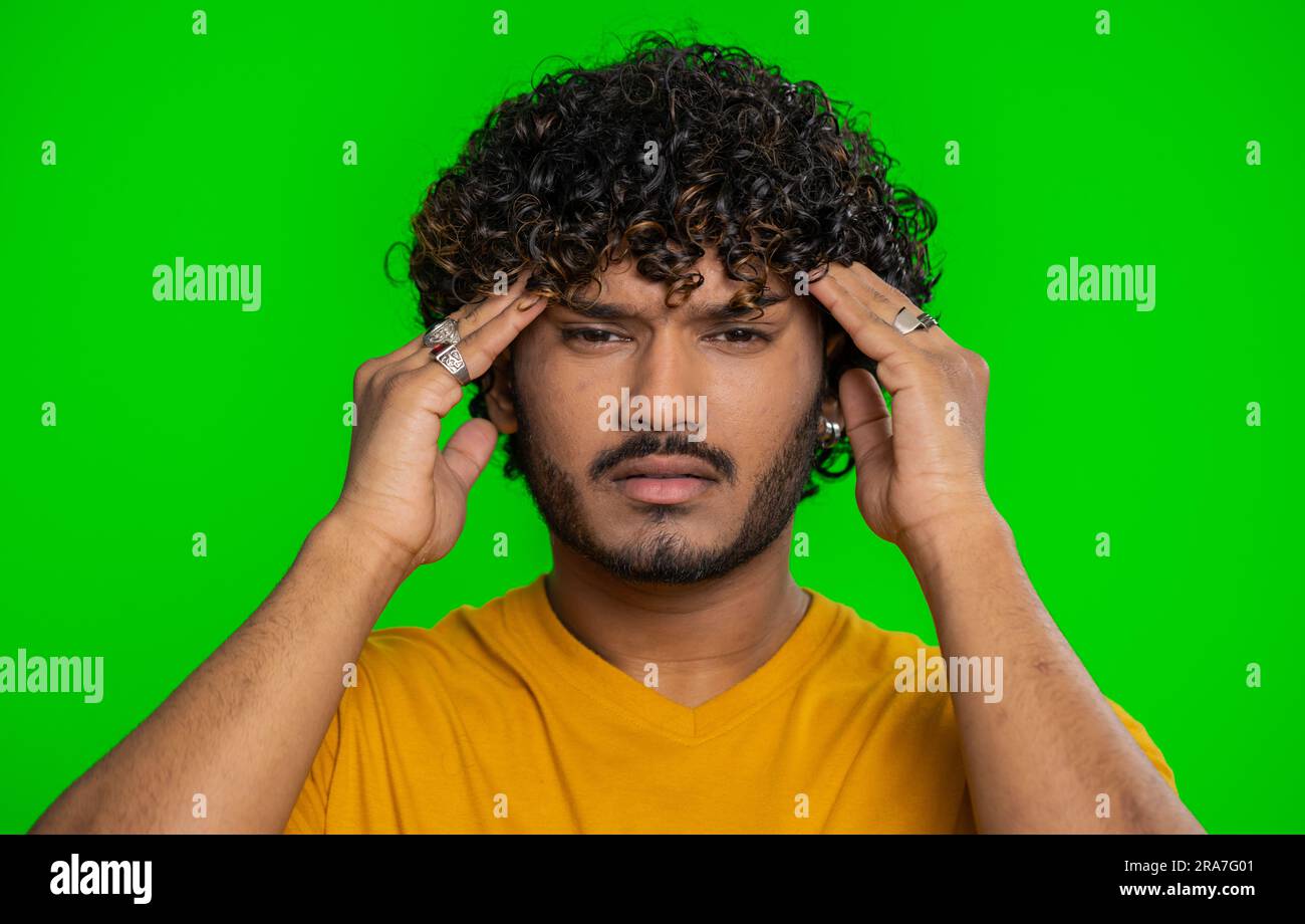 Handsome indian bearded man in shirt rubbing temples to cure headache ...