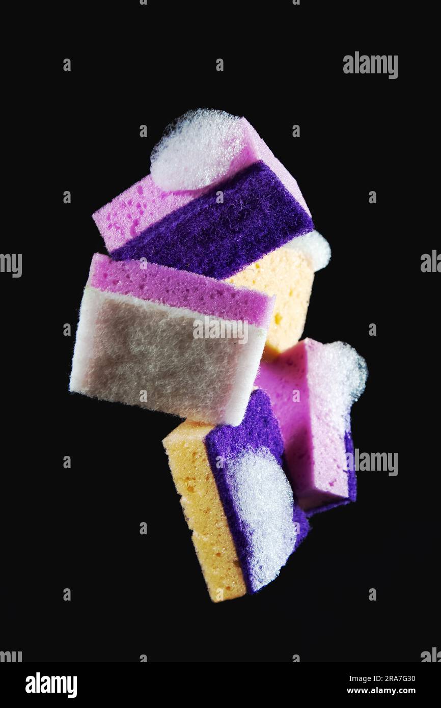Flying sponges for washing dishes. Black background Stock Photo - Alamy