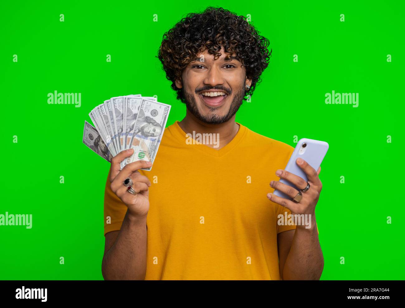 Indian man looking smartphone display sincerely rejoicing win ...