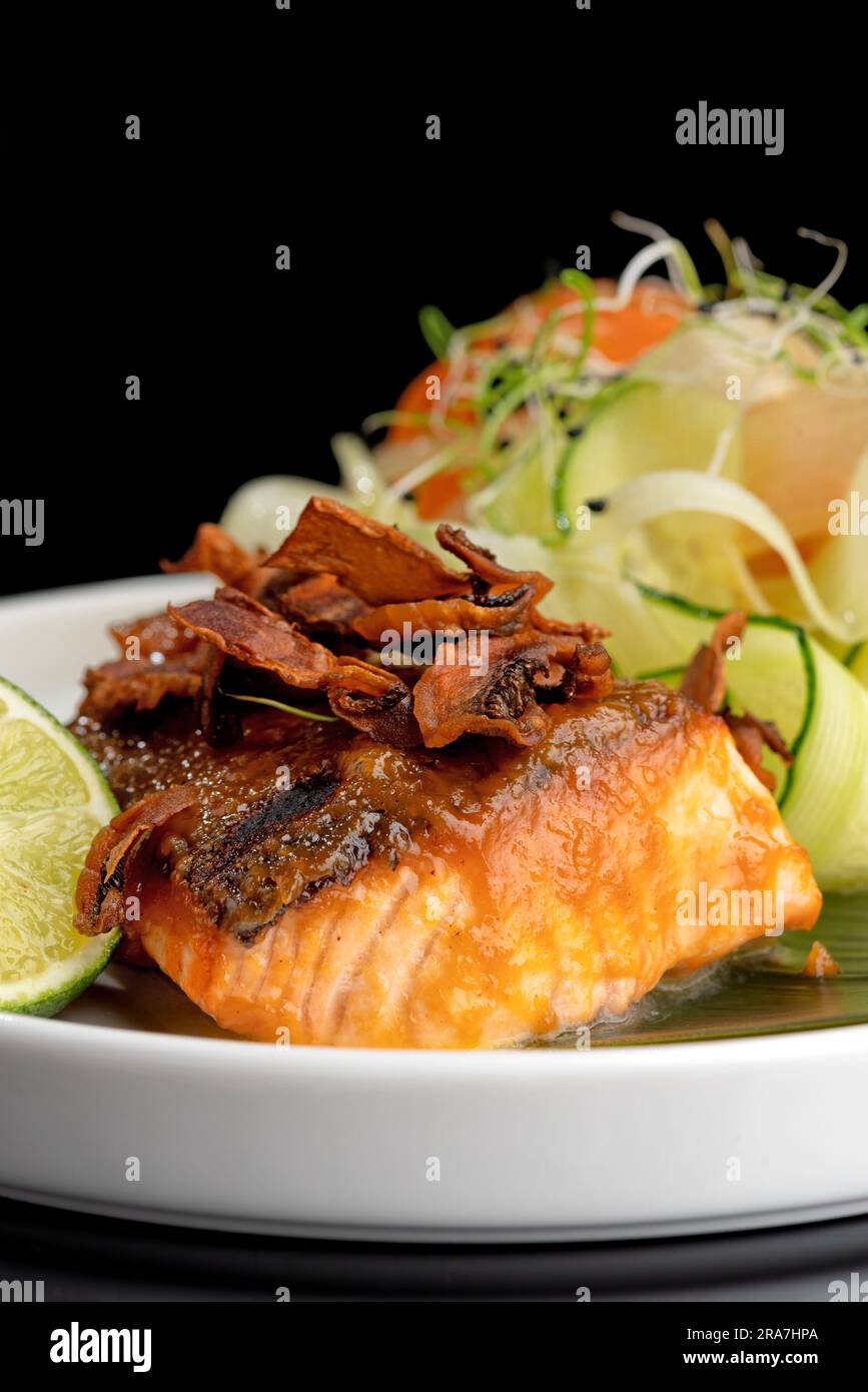 fresh perch fish fillet and herbs on a black background with reflection ...