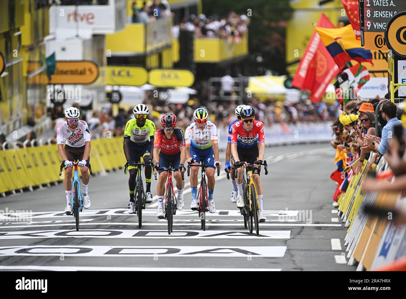 Cyclists entering the finish line lagging behind in a stage of the 2023 ...