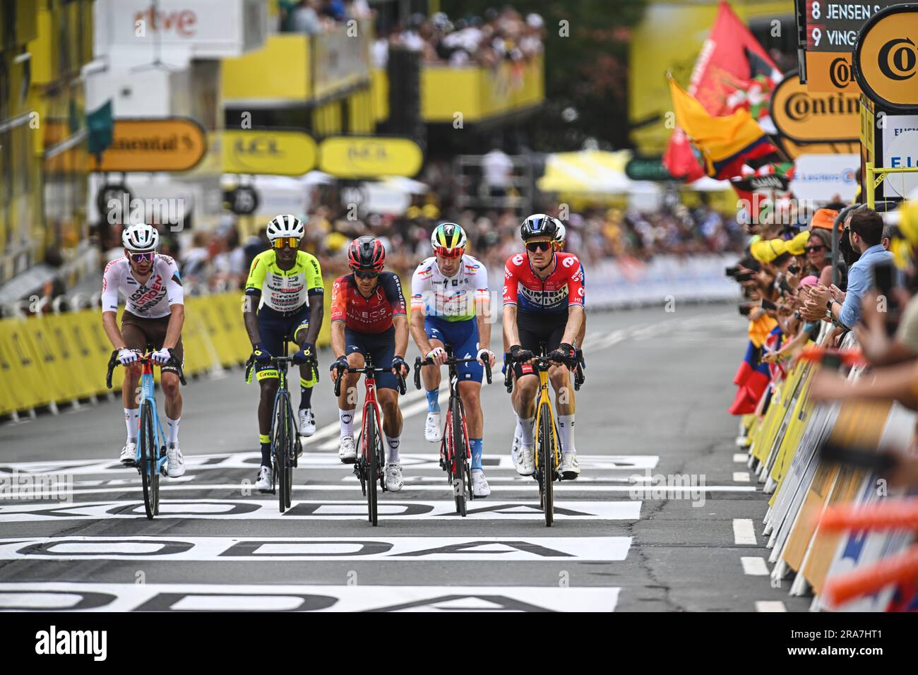 Cyclists entering the finish line lagging behind in a stage of the 2023 ...