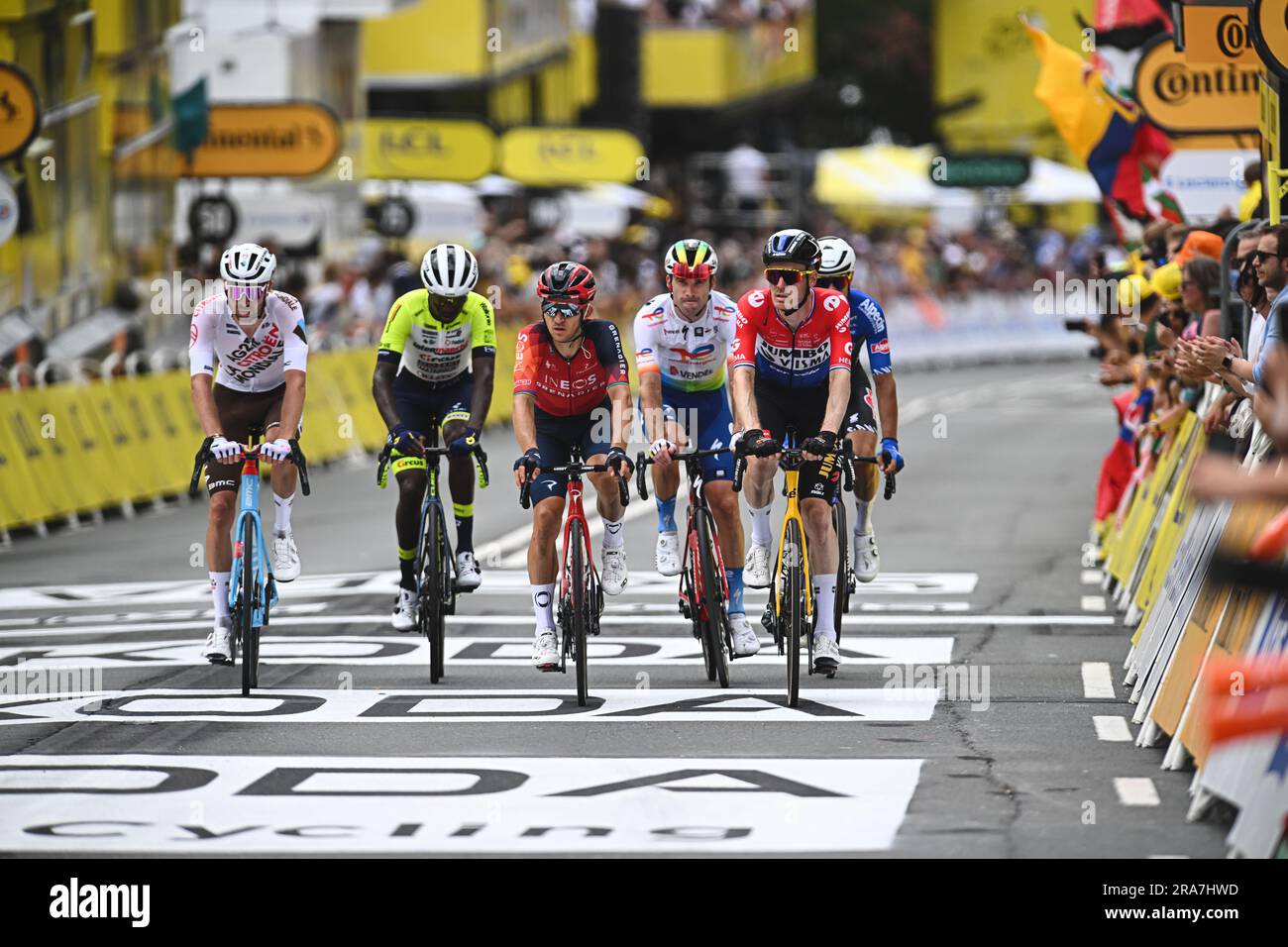 Cyclists entering the finish line lagging behind in a stage of the 2023 ...