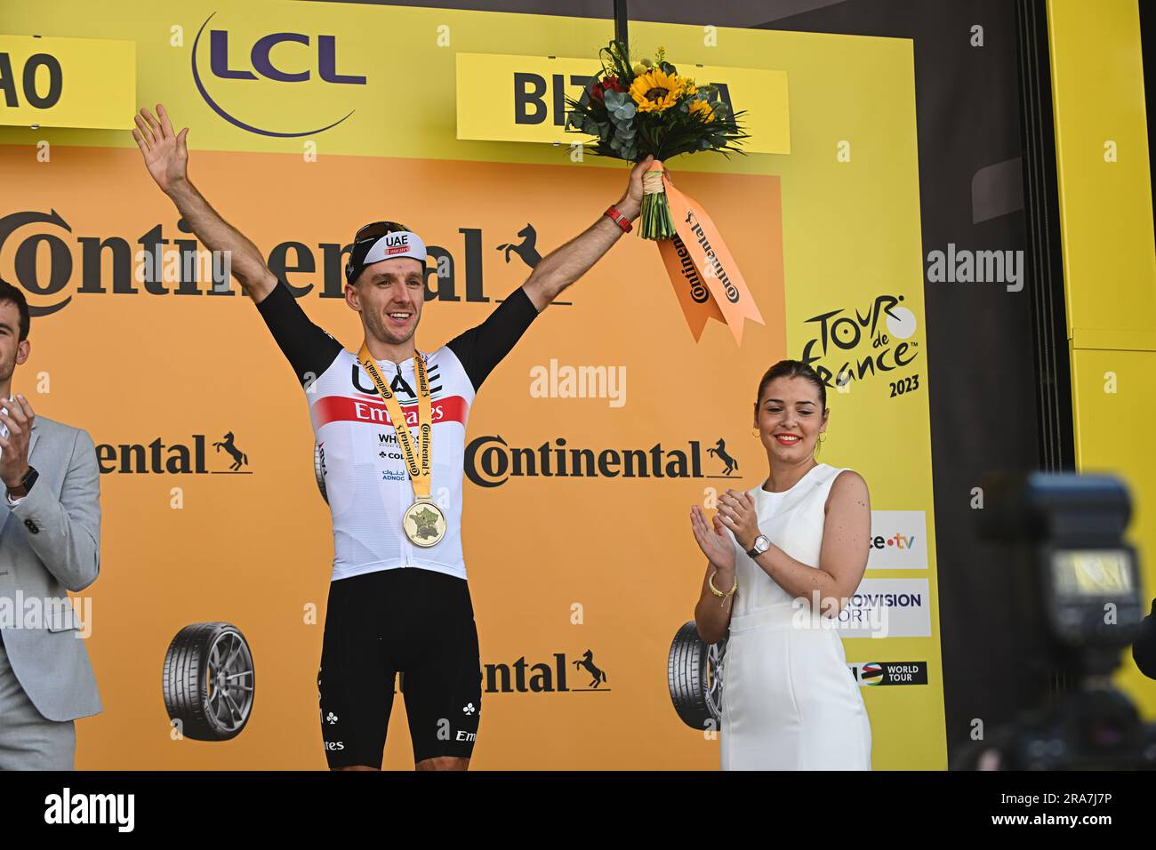 Adam Yates on the podium in Bilbao as the winner of the 2023 Tour de ...