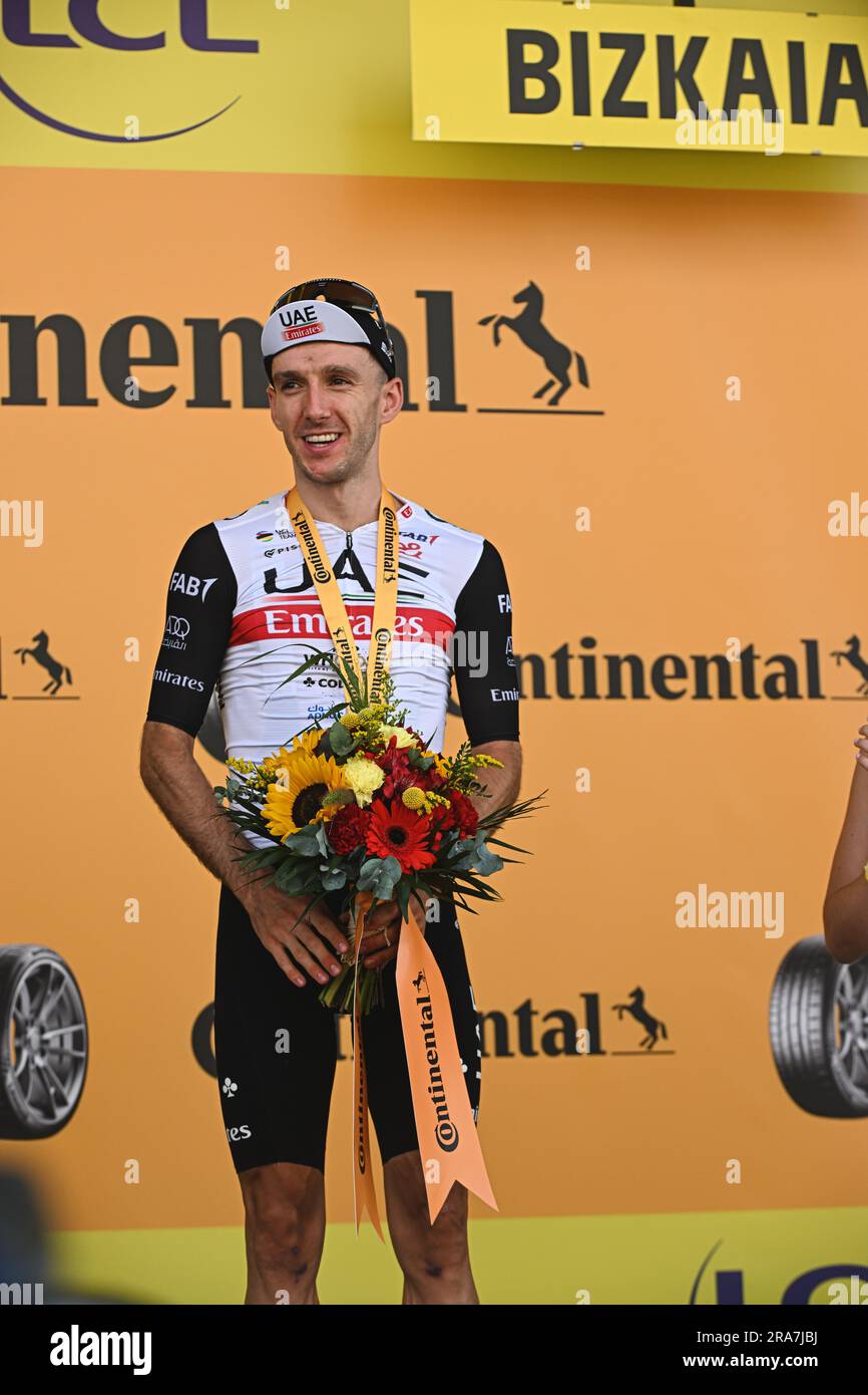Adam Yates on the podium in Bilbao as the winner of the 2023 Tour de ...