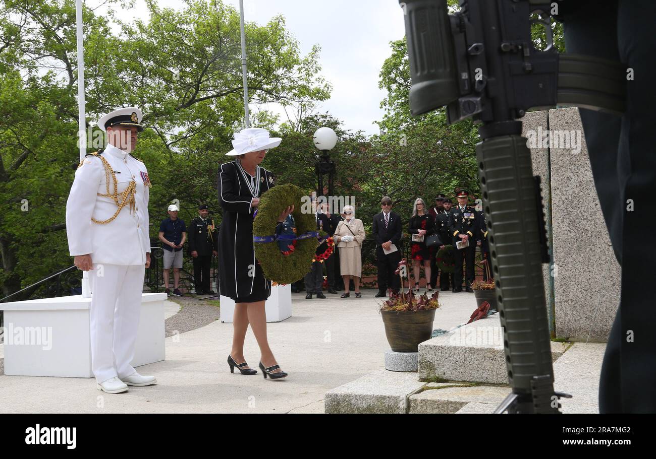 Lieutenant Governor Judy Foote places a wreath, assisted by Aide-de ...