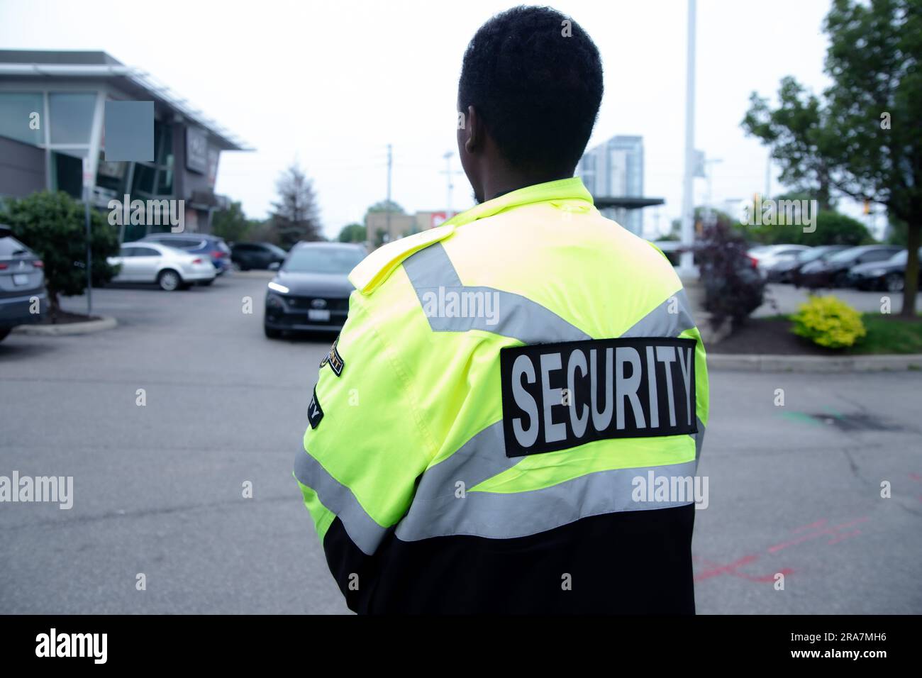 Security guard patrolling office parking space Stock Photo - Alamy