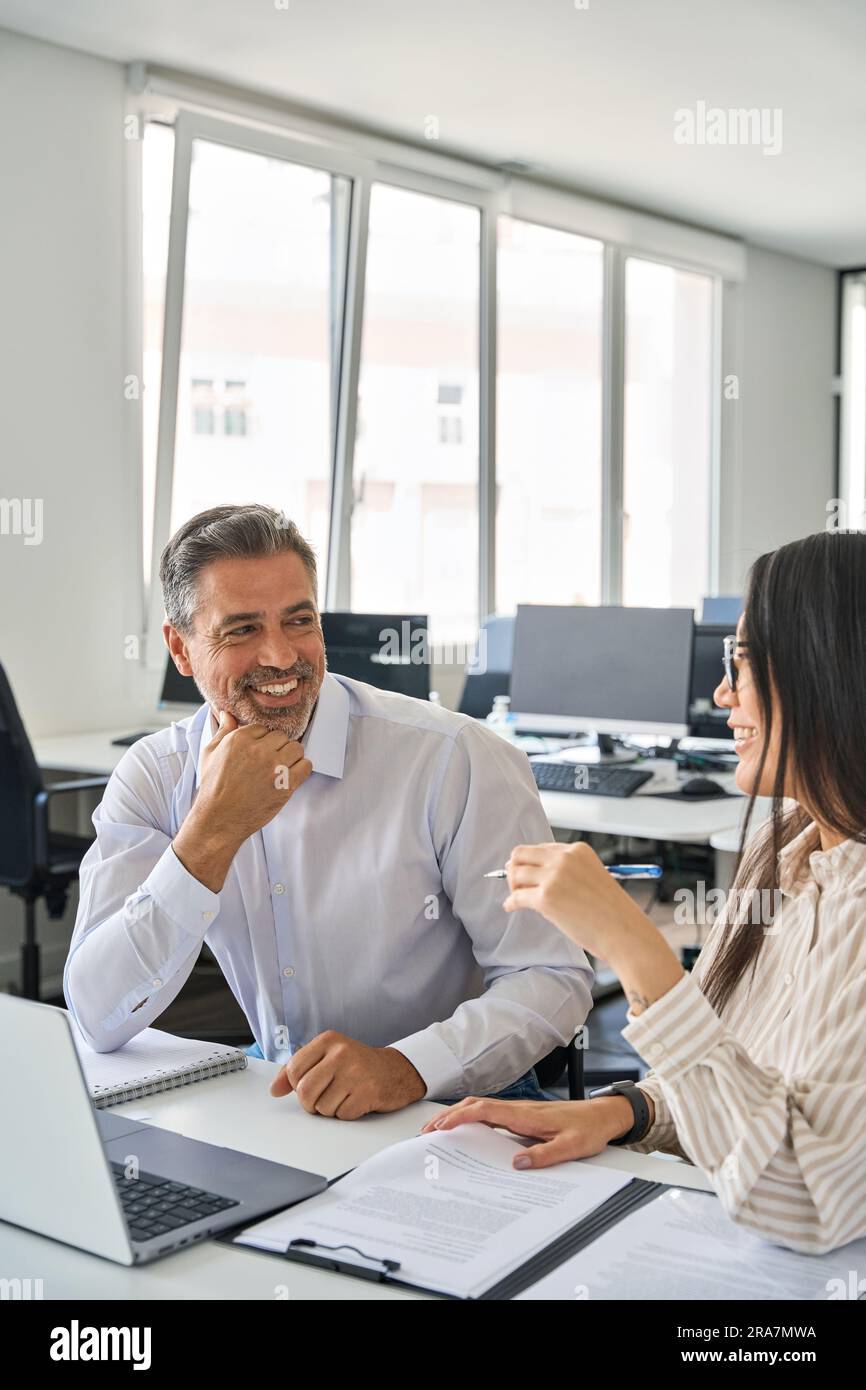 Happy diverse professional workers working in office with laptop ...