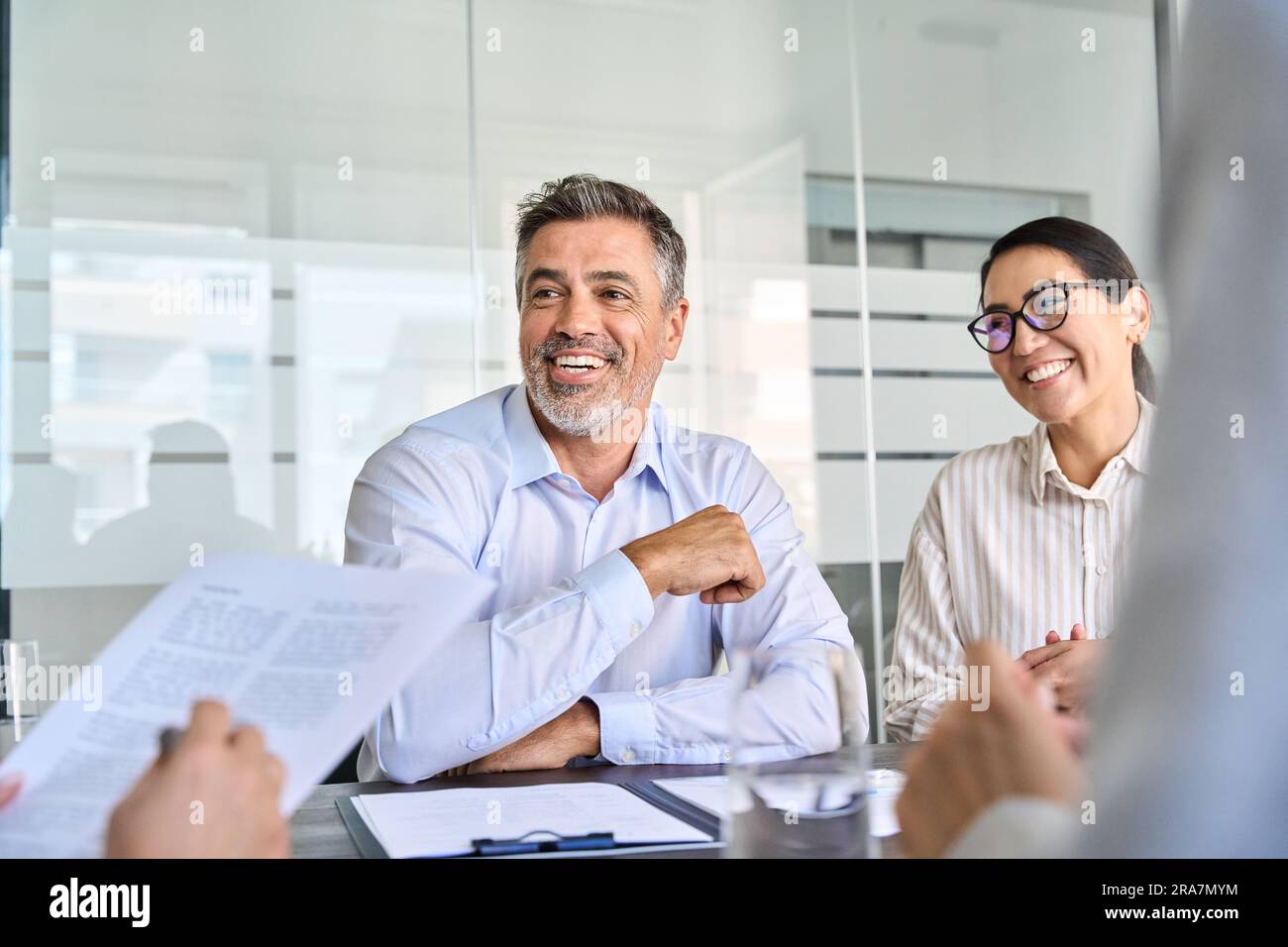 Happy business people international executive team talking at group ...