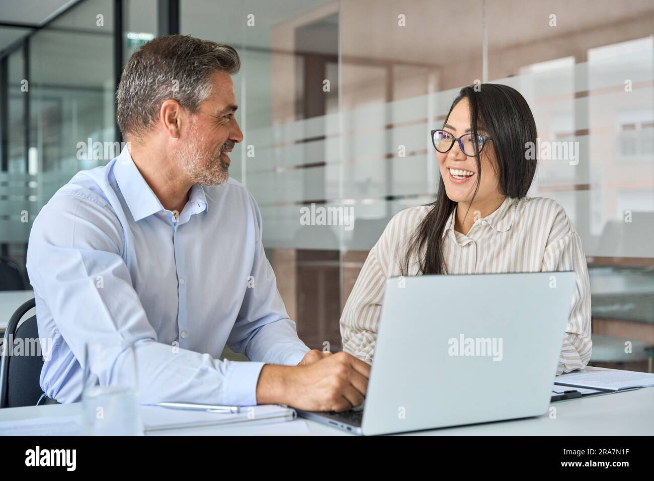 Two young professionals collaborating in hi-res stock photography and ...