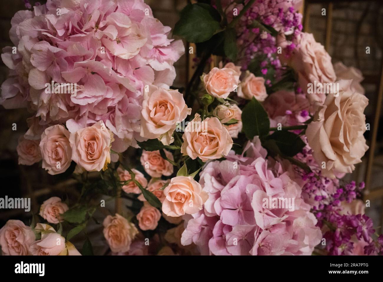 Chivalric wedding with pillars of candles and roses in glass vases ...