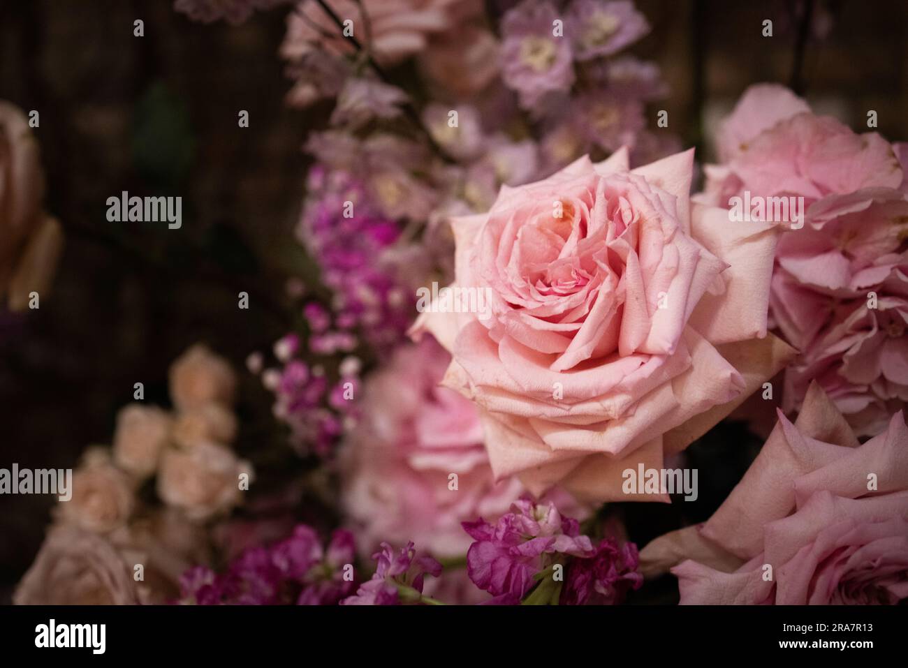 Chivalric wedding with pillars of candles and roses in glass vases ...