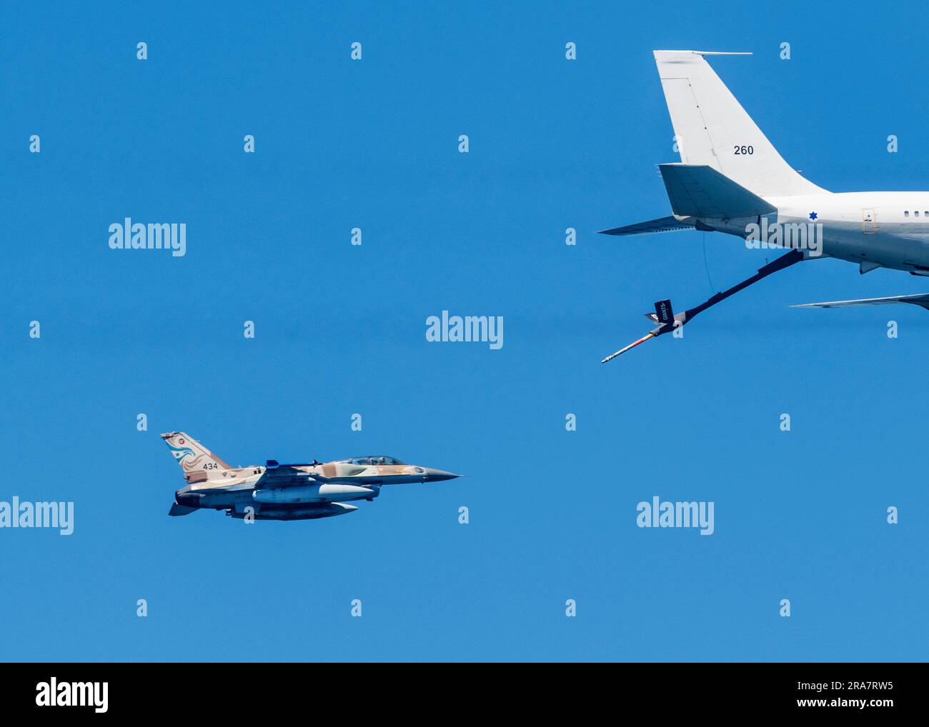 Israel Air Force F16 pulling up to refueling tanker in clear blue sky ...