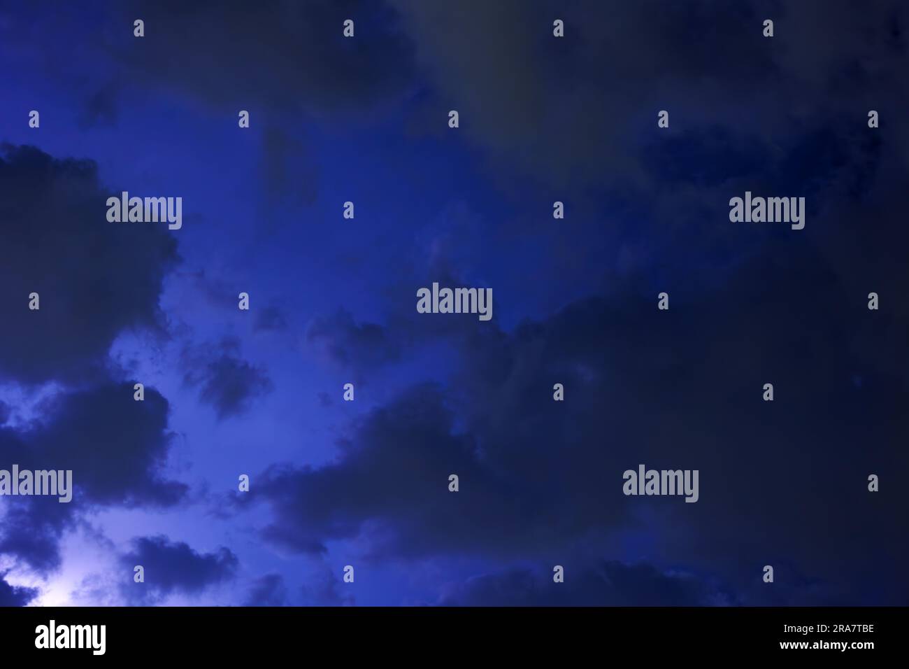 The clouds move fast across the dark night sky, the flashes of light ...