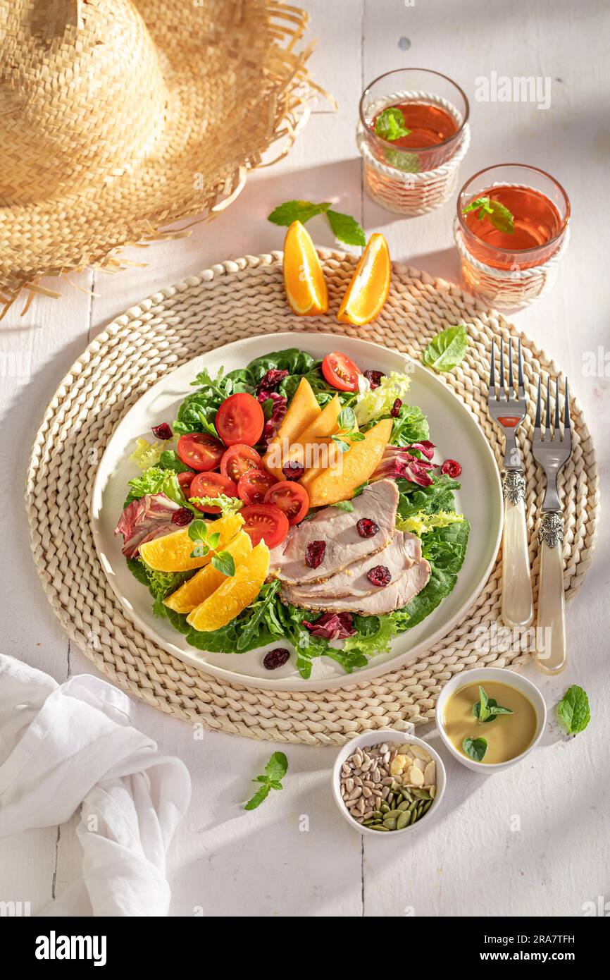 Homemade salad with beef, melon, cranberries and tomatoes. Salad made ...