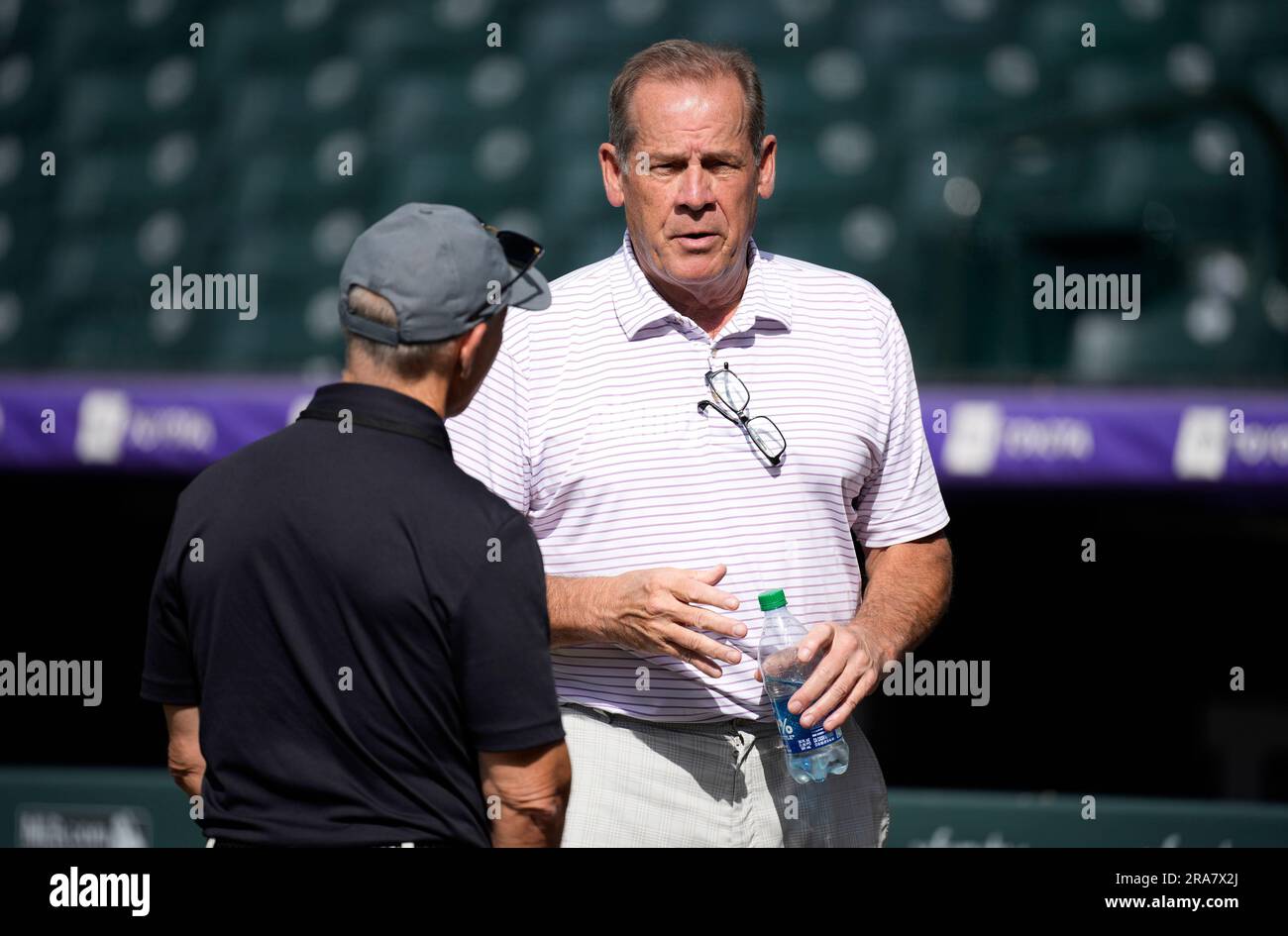Colorado Rockies co-owner Dick Monfort, back, chats with the team's ...
