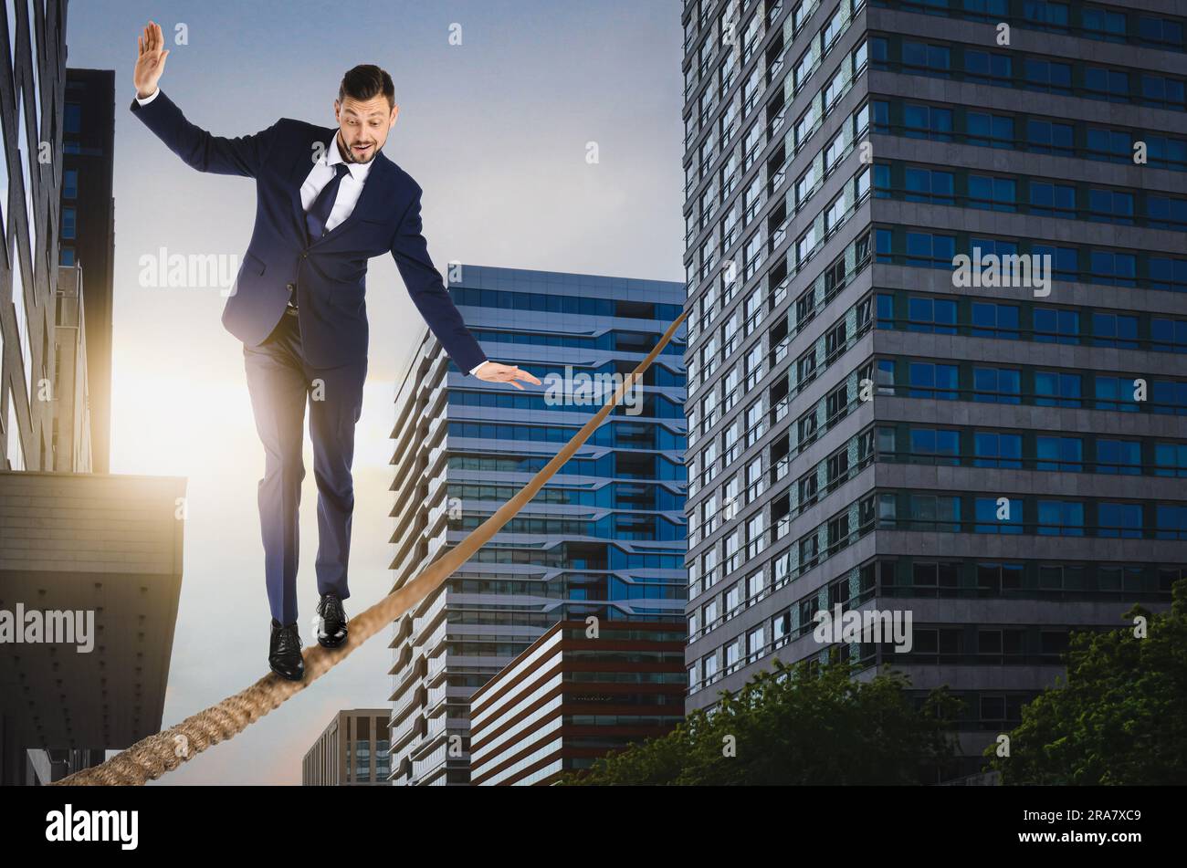 Risks and challenges of entrepreneurship. Businessman balancing on rope ...