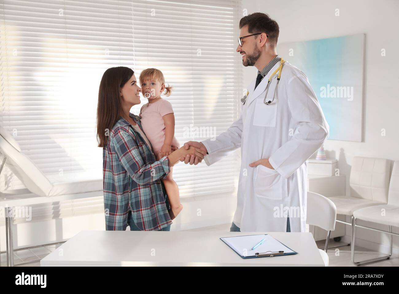 Mother and her cute baby having appointment with pediatrician in clinic ...