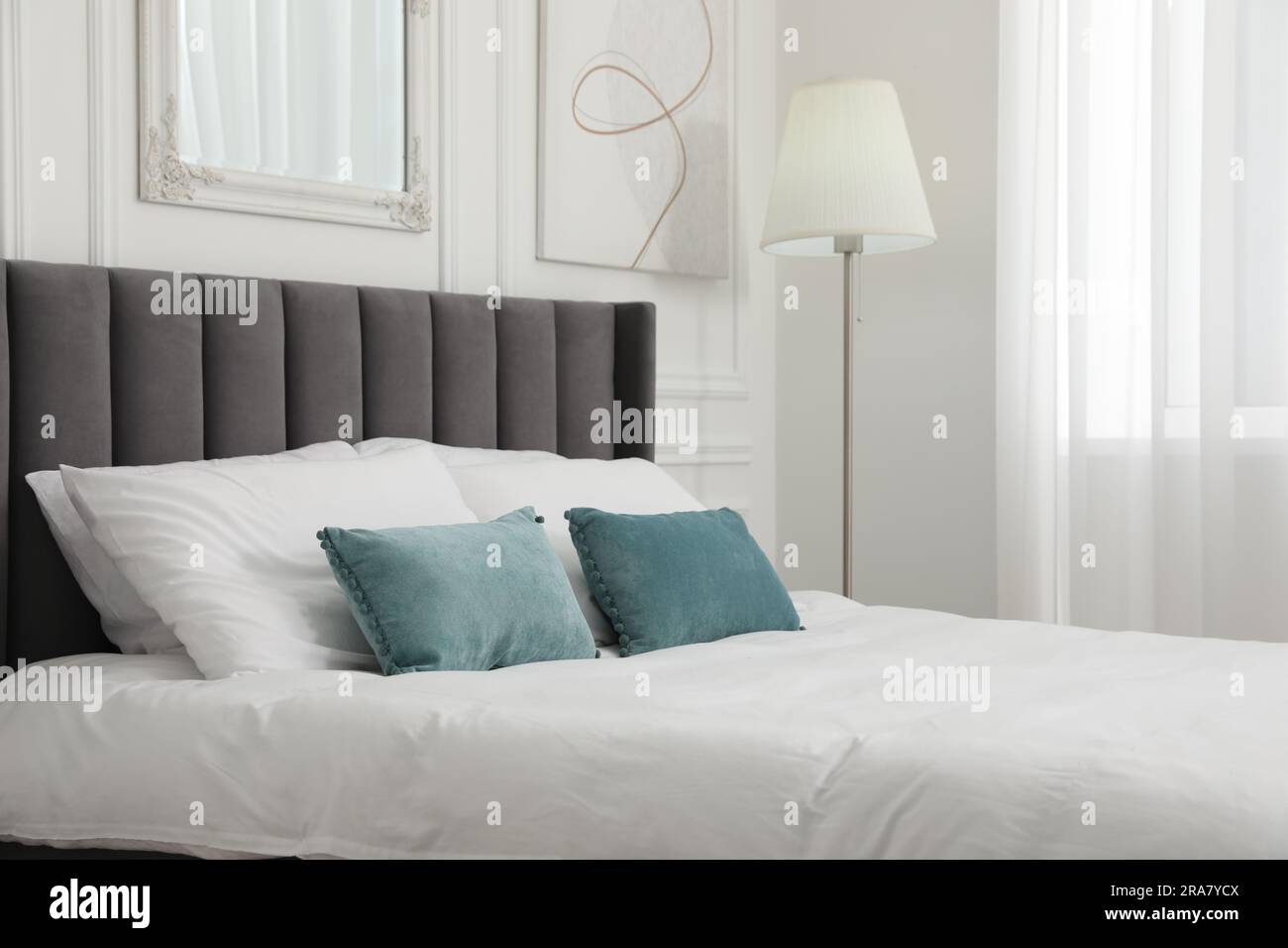 Large comfortable bed with cushions in bedroom. Interior design Stock ...