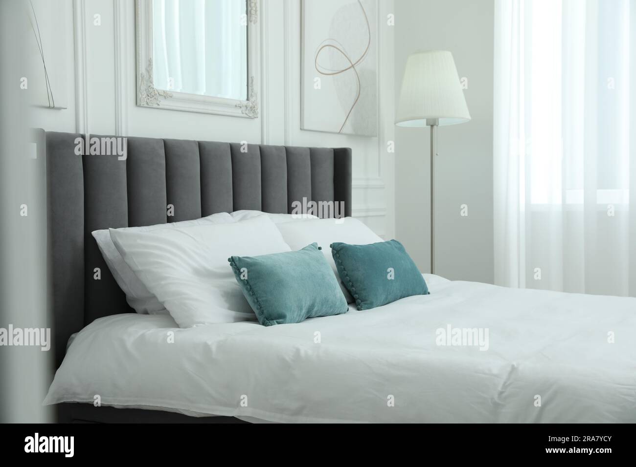 Large comfortable bed with cushions in bedroom. Interior design Stock ...