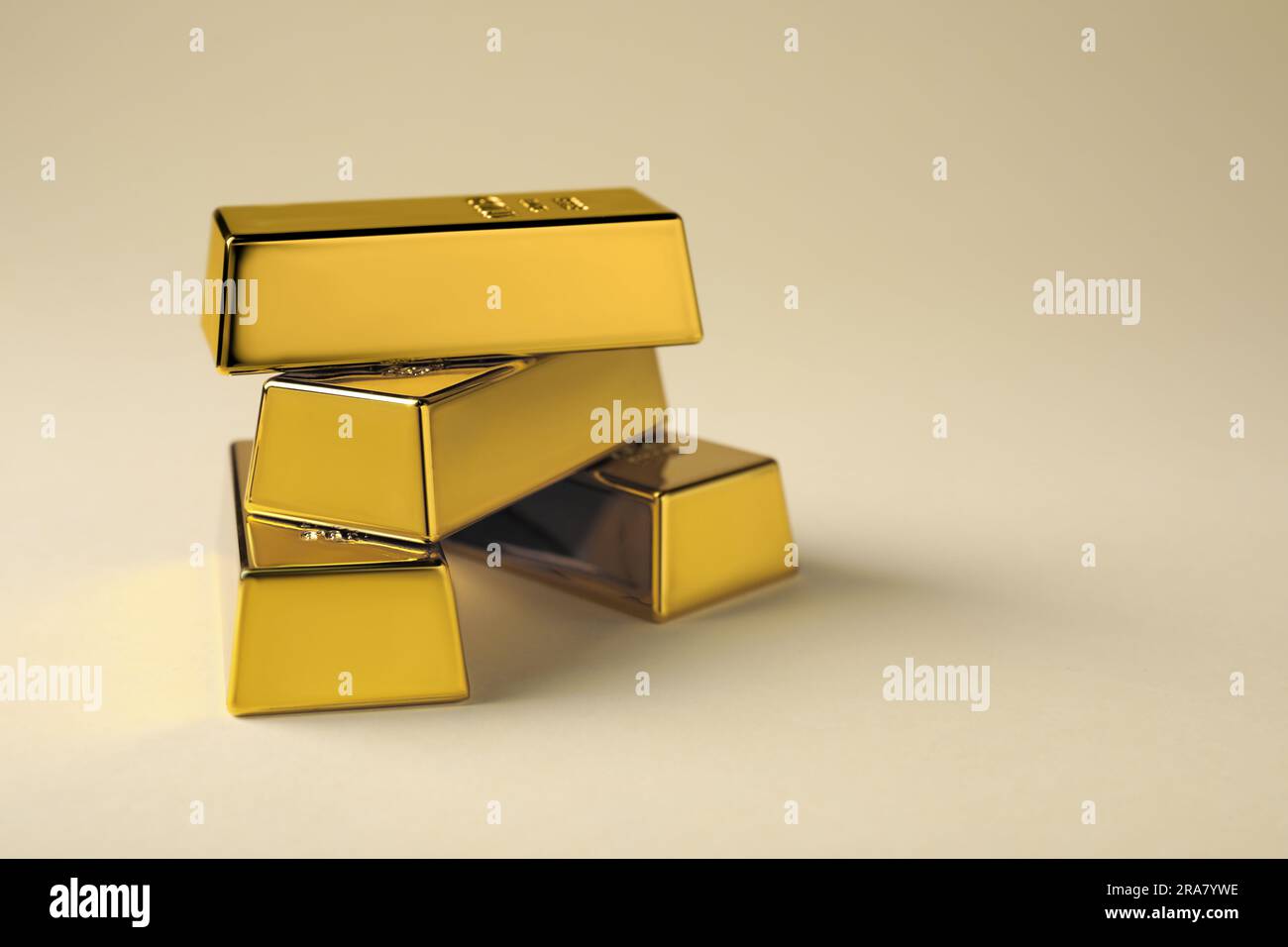 Many shiny gold bars on beige background. Space for text Stock Photo - Alamy