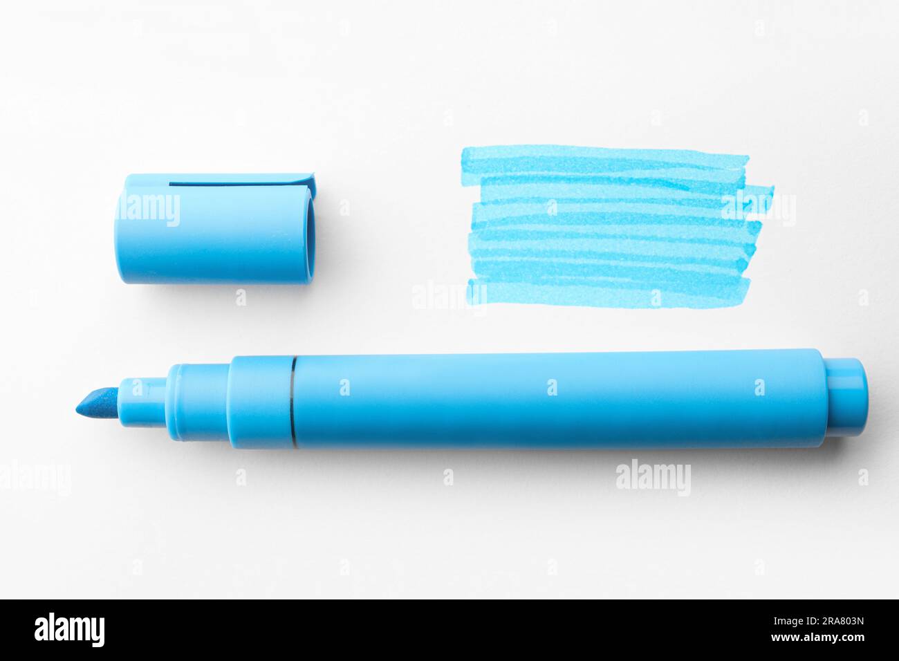 Different strokes drawn with light blue marker and highlighter on white ...