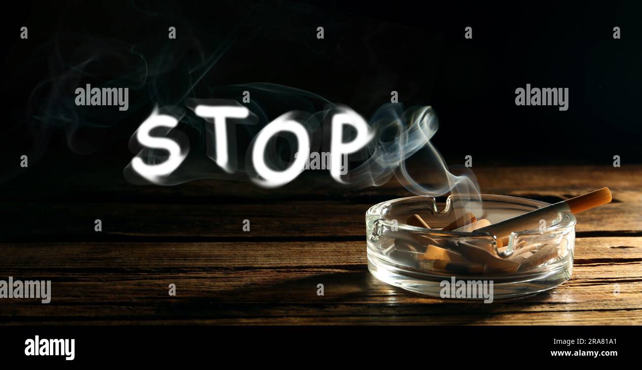 Quit smoking. Word Stop of smoke, ashtray with stubs and smoldering ...
