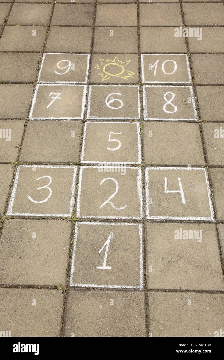 Hopscotch drawn with white chalk on street tiles outdoors Stock Photo ...