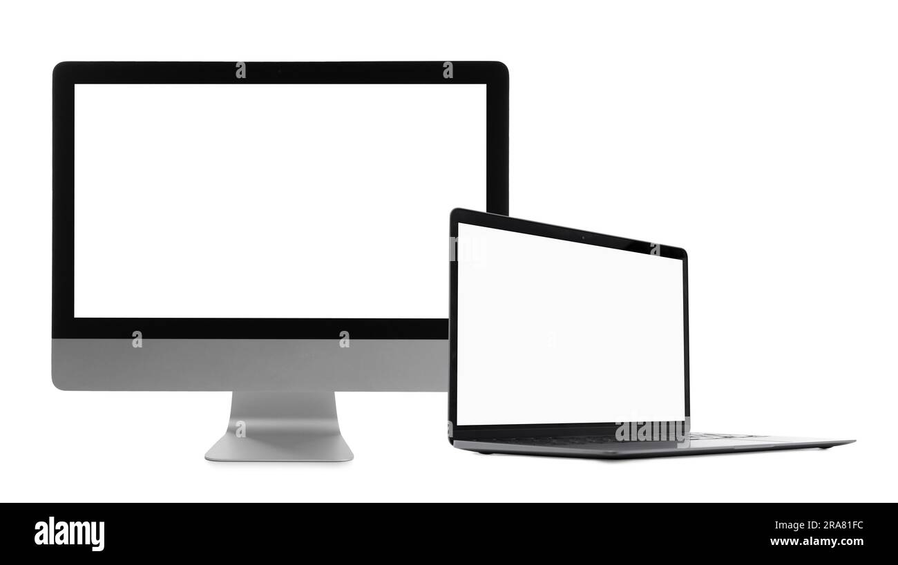 Computer monitor and laptop with blank screens on white background ...
