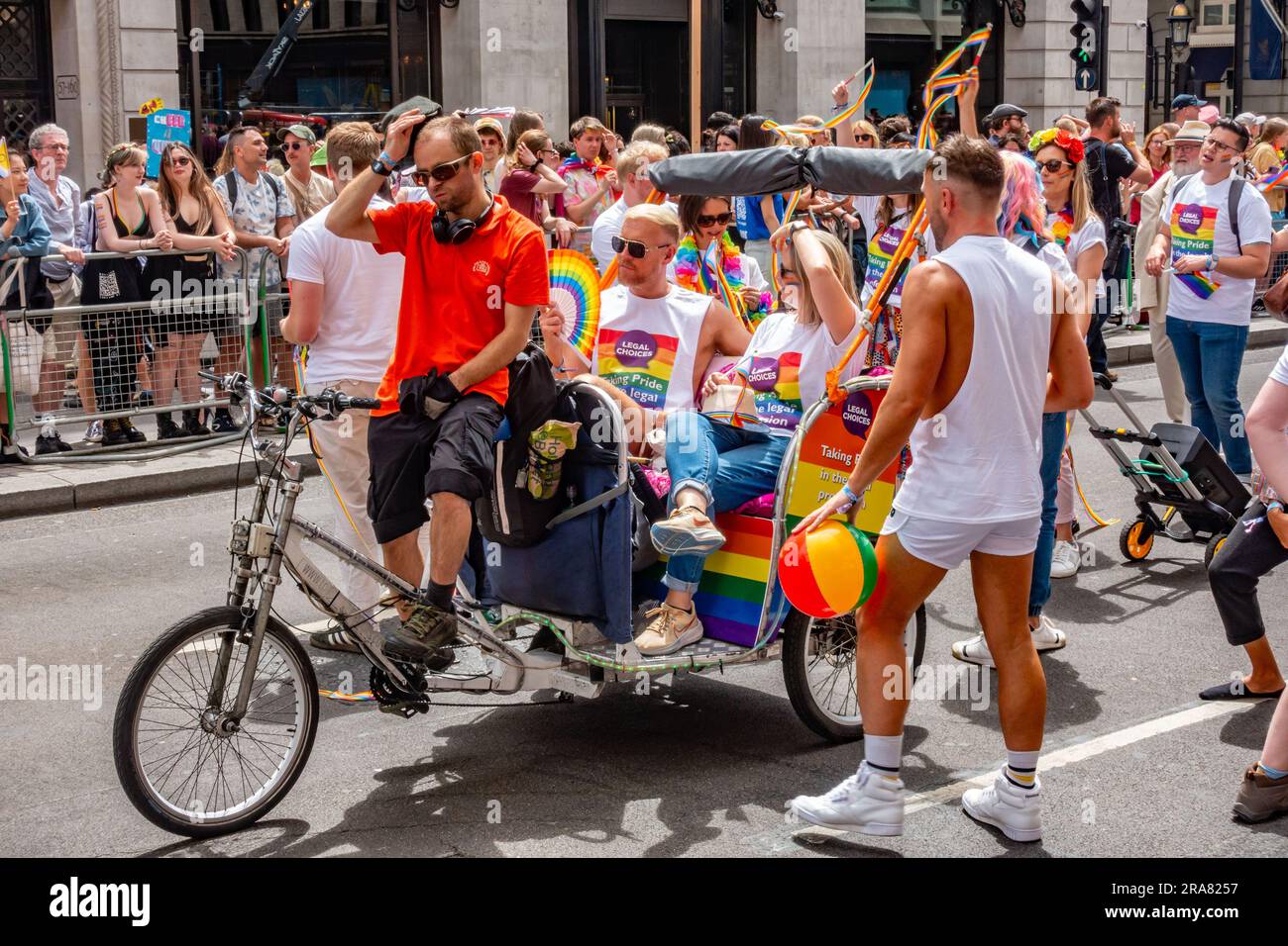 People riding in a tricycle as part of the London Pride 2023 parade ...