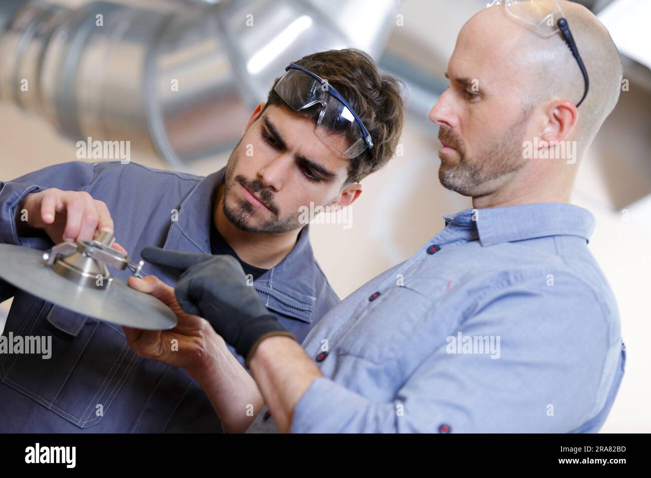 male apprentice checking a material Stock Photo - Alamy