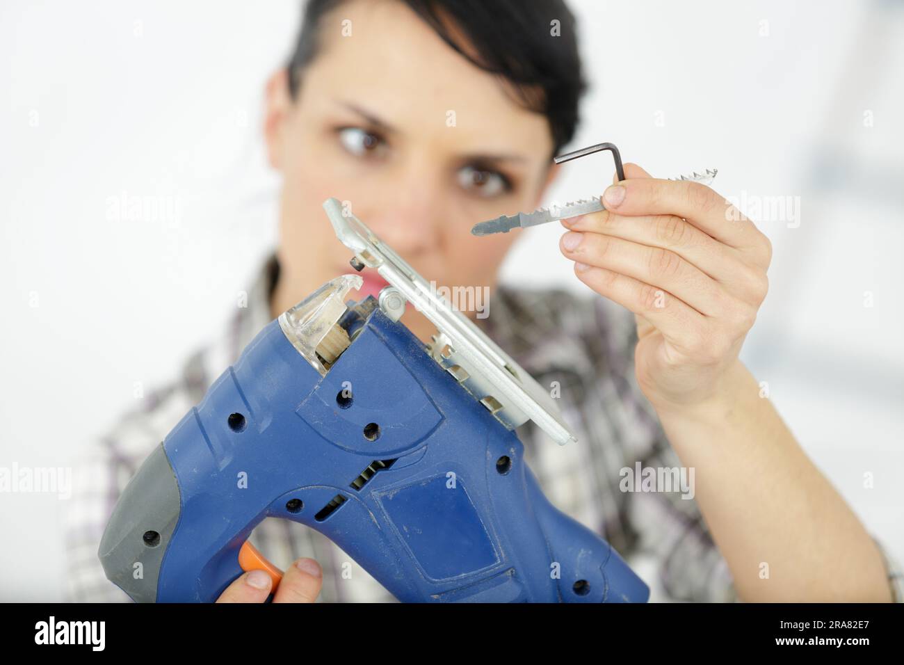 woman struggling to use a cutting machine Stock Photo - Alamy