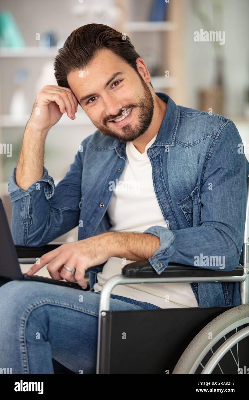disabled man in wheelchair using notebook computer Stock Photo - Alamy