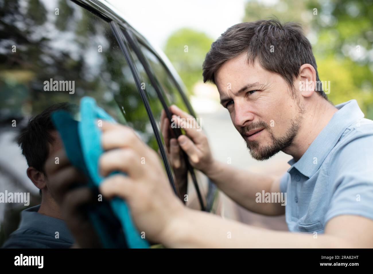 young man cleaning his car outdoors Stock Photo - Alamy