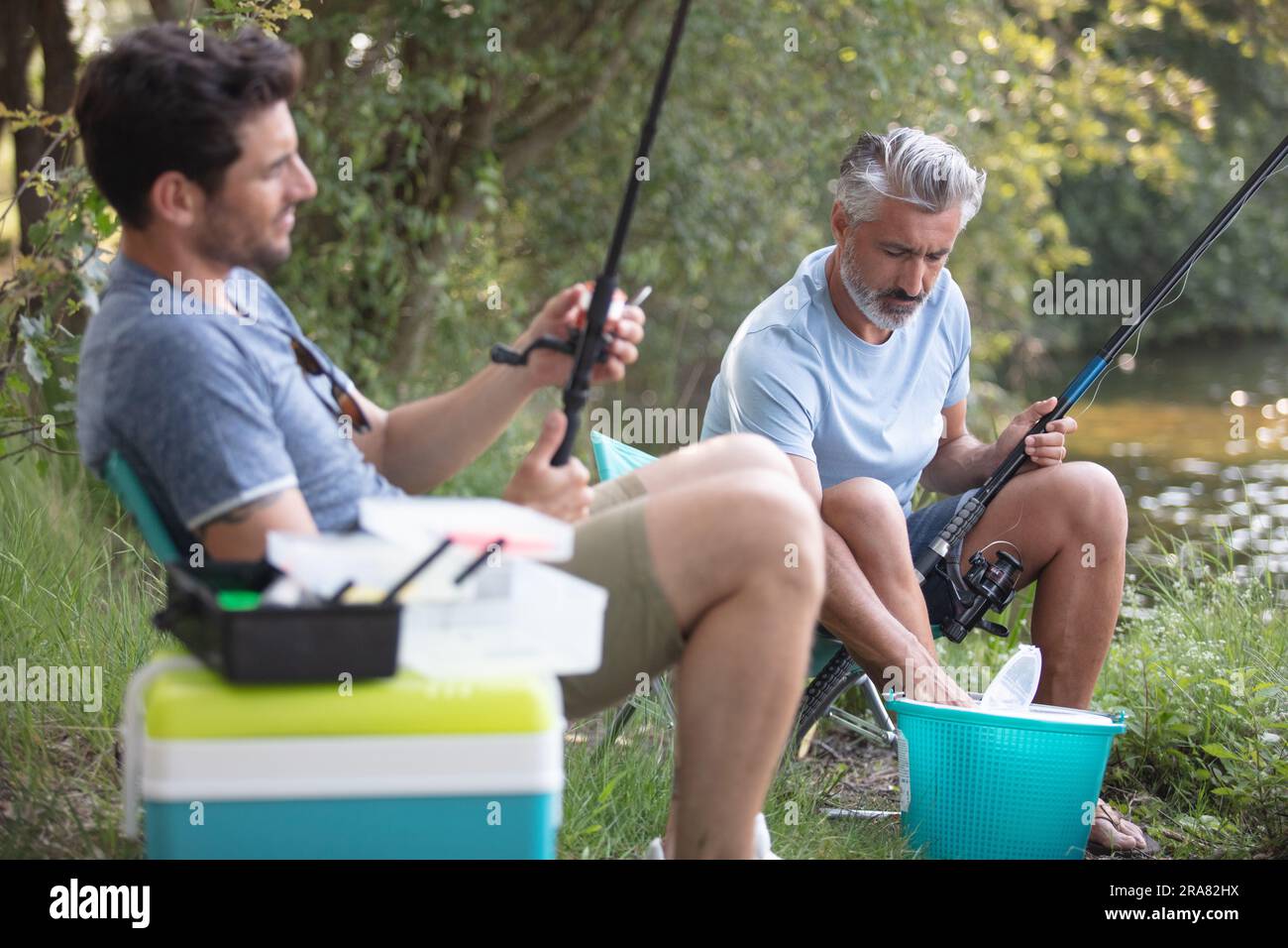 two men are fishing together Stock Photo - Alamy