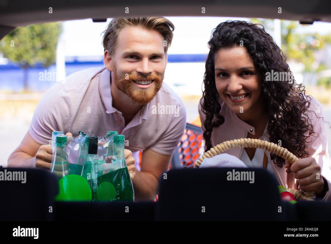 couple packing shopping bags with fresh food into the trunk Stock Photo ...