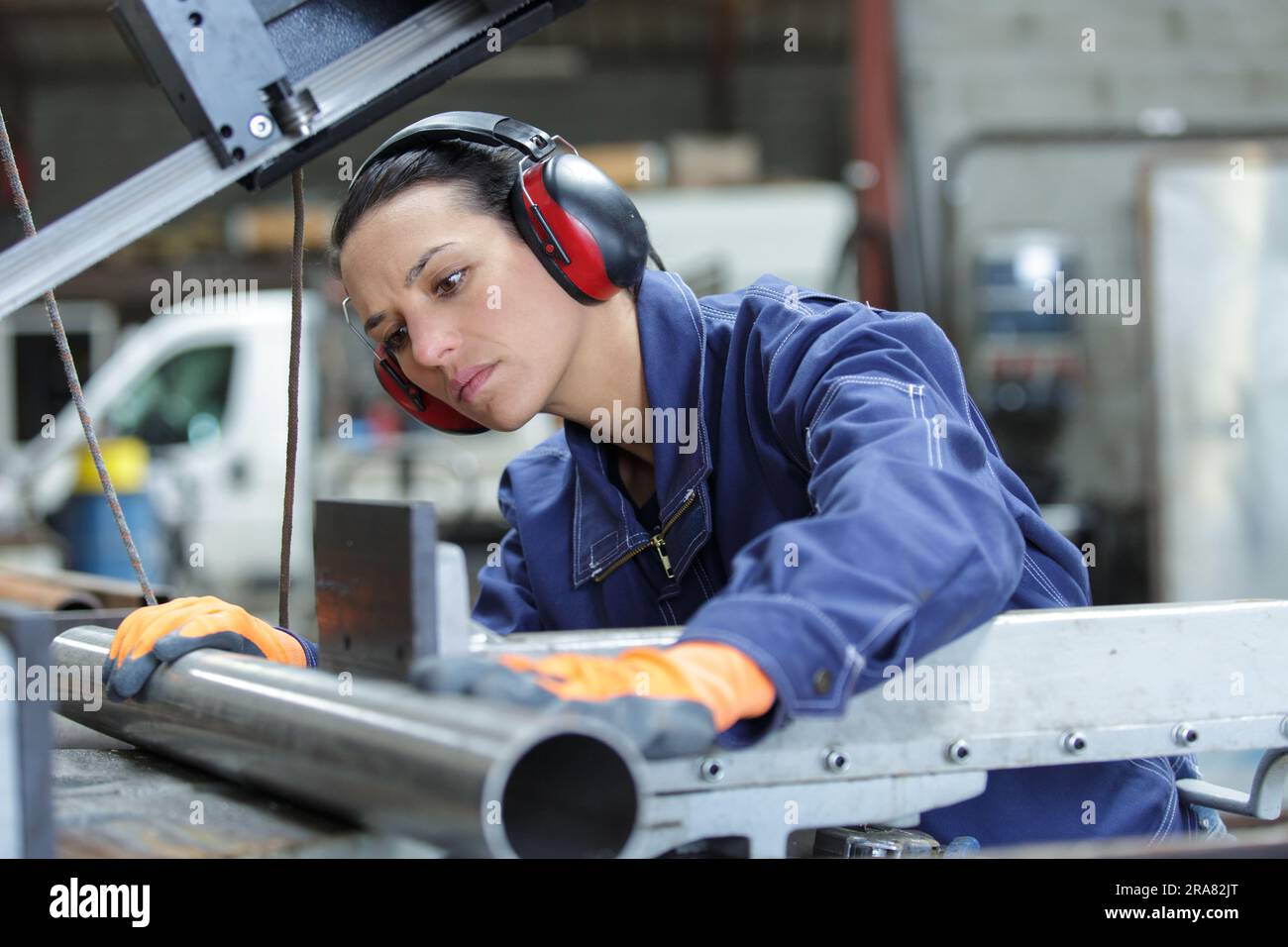 female handling machinery in a metal workshop Stock Photo - Alamy