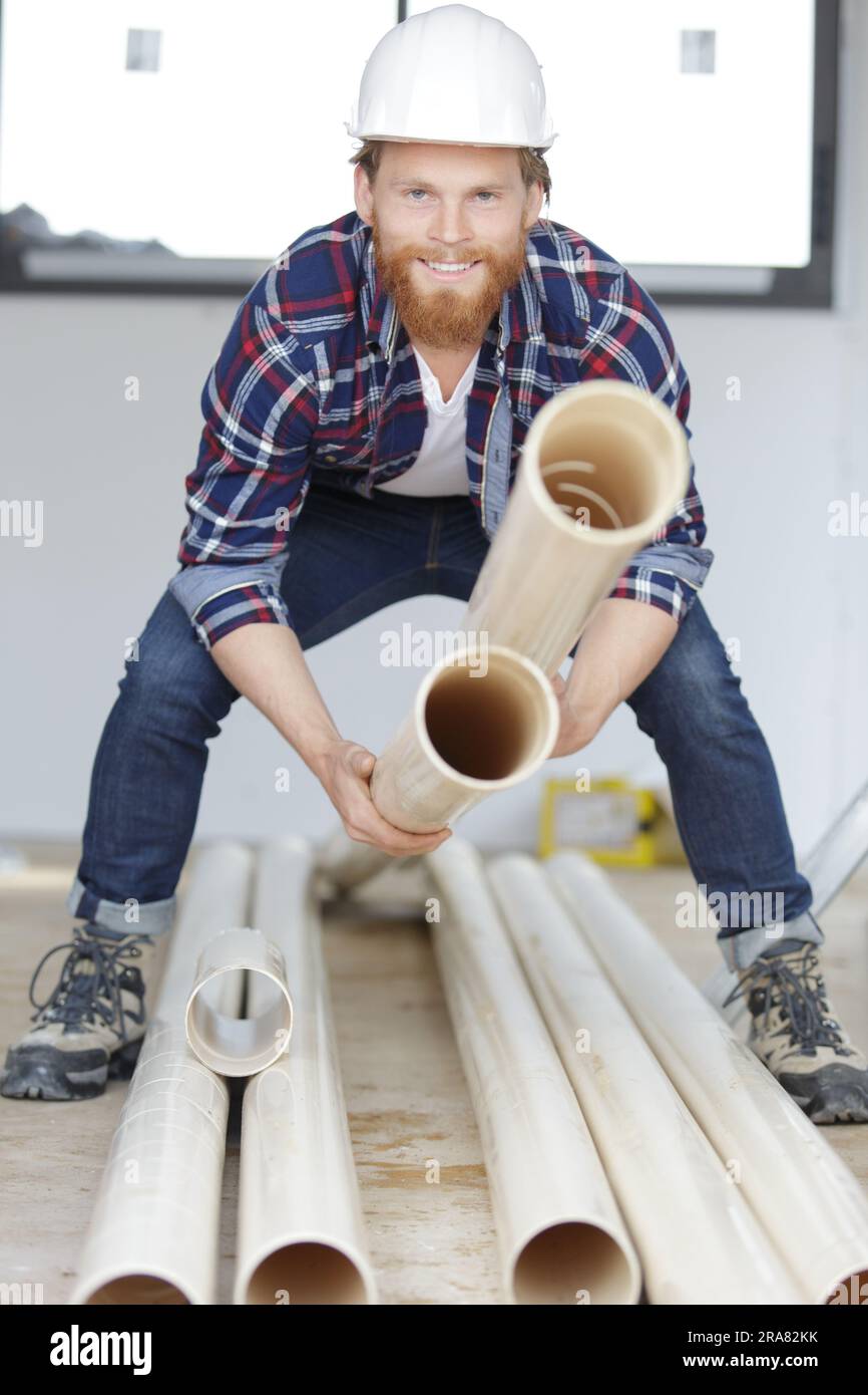 Young worker plastic pipes hi-res stock photography and images - Alamy
