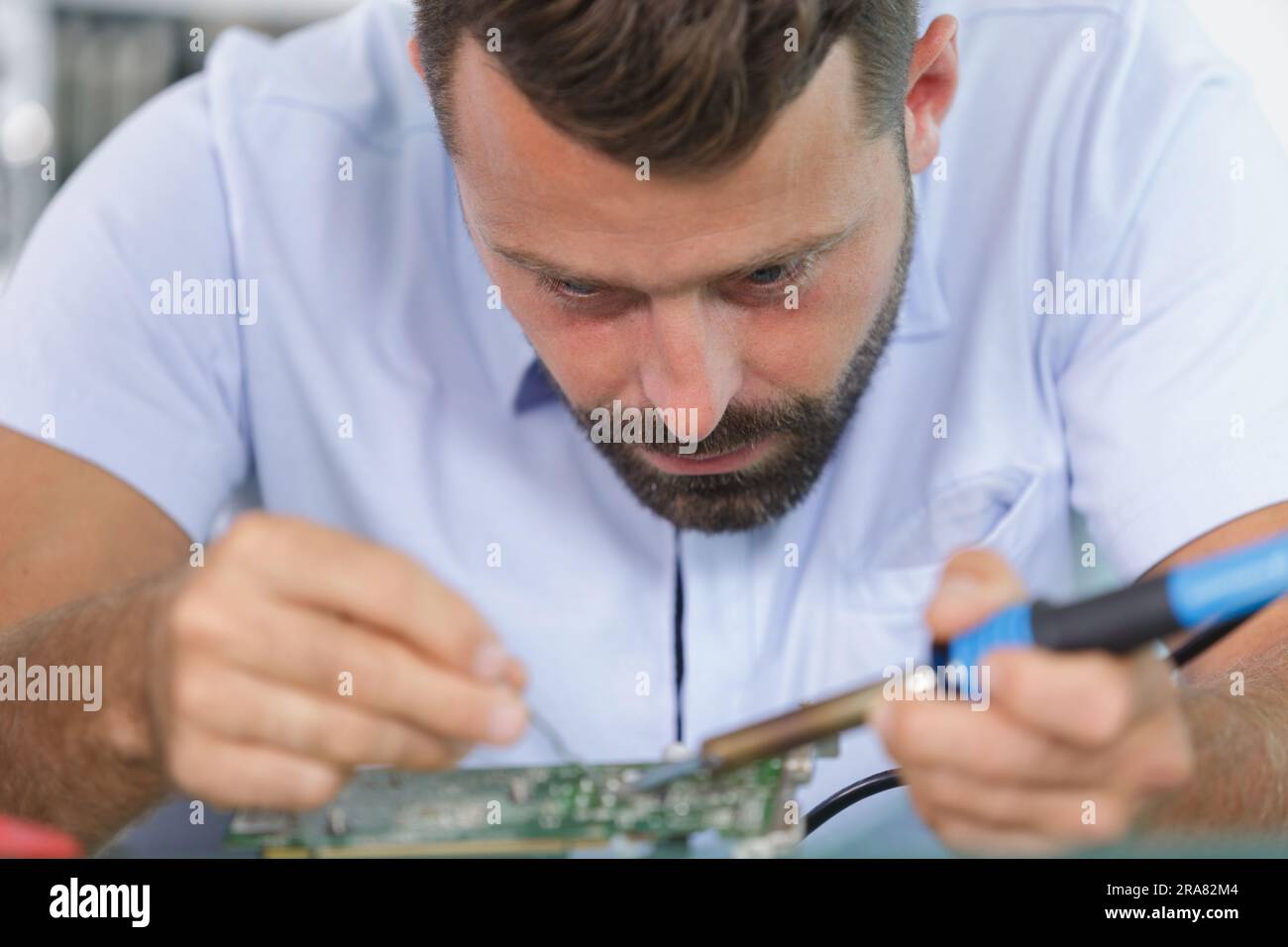 Young man soldering hi-res stock photography and images - Alamy