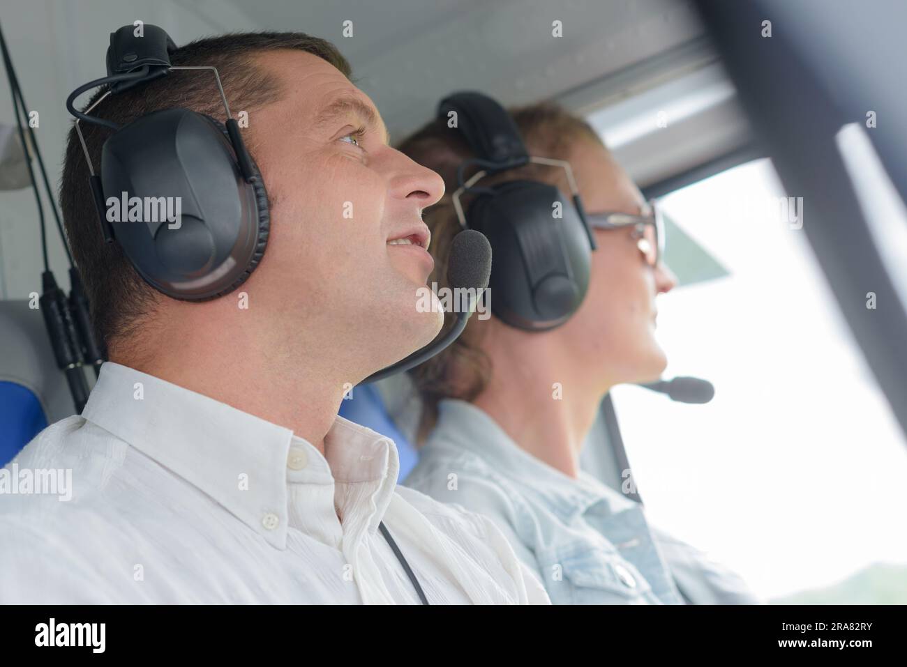 close view of man and woman in aircraft wearing headsets Stock Photo ...