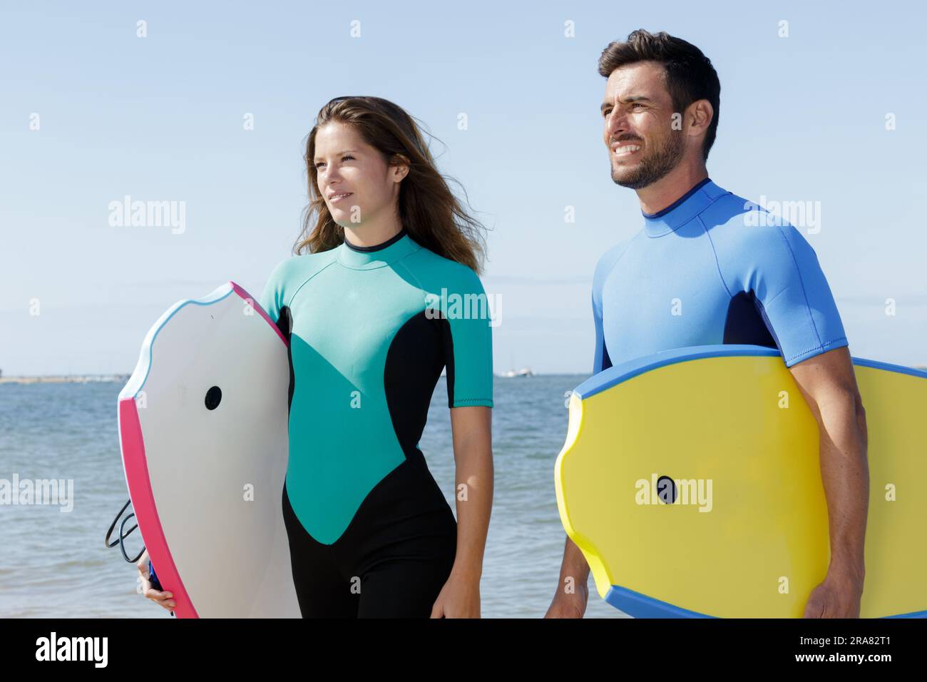 surfer beginner and instructor on a beach Stock Photo - Alamy