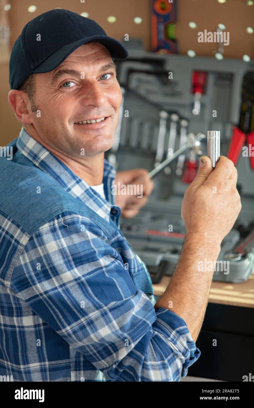 smiling handyman toolbox against white background Stock Photo - Alamy