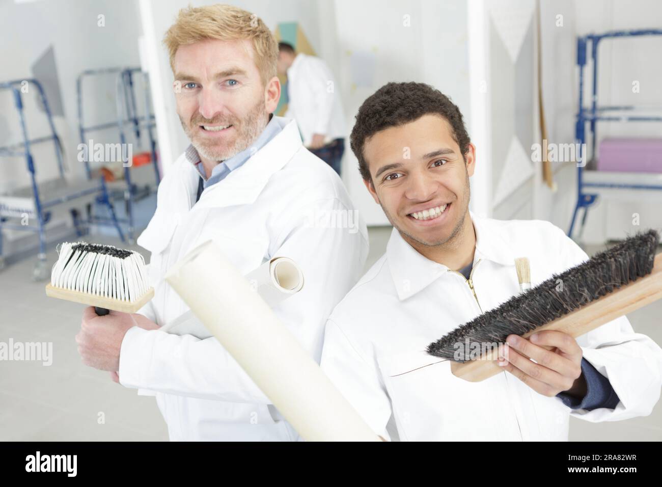 two painters posing back to back Stock Photo - Alamy